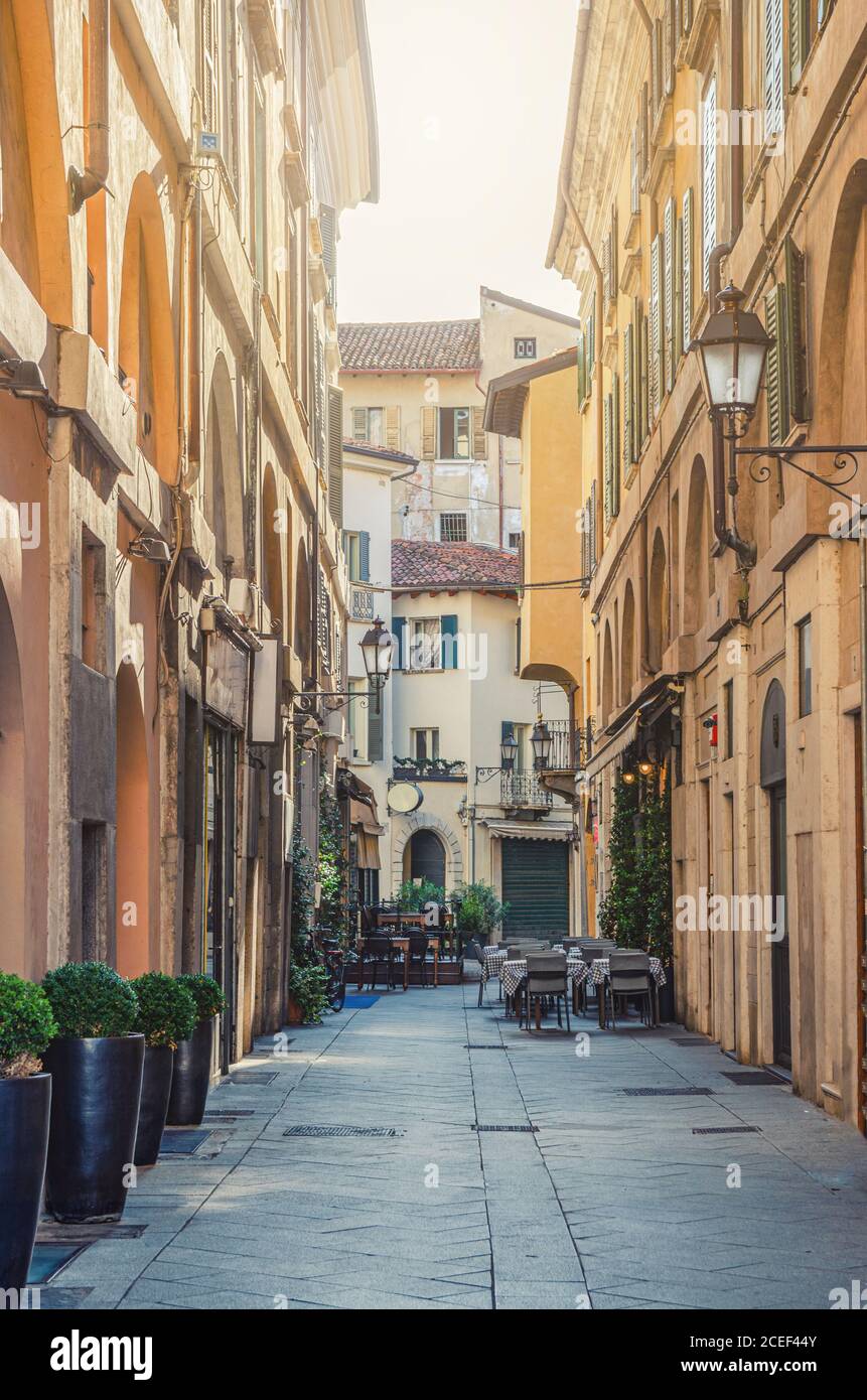 Typical italian street with old colorful buildings with shutter windows ...