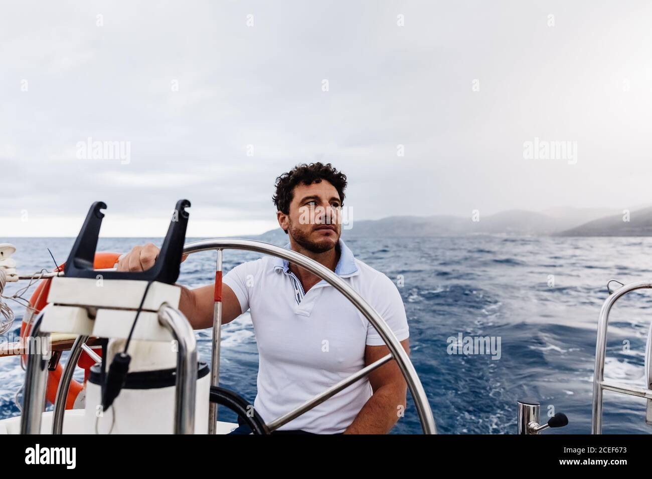 Captain of a ship sailing on a sailboat Stock Photo - Alamy