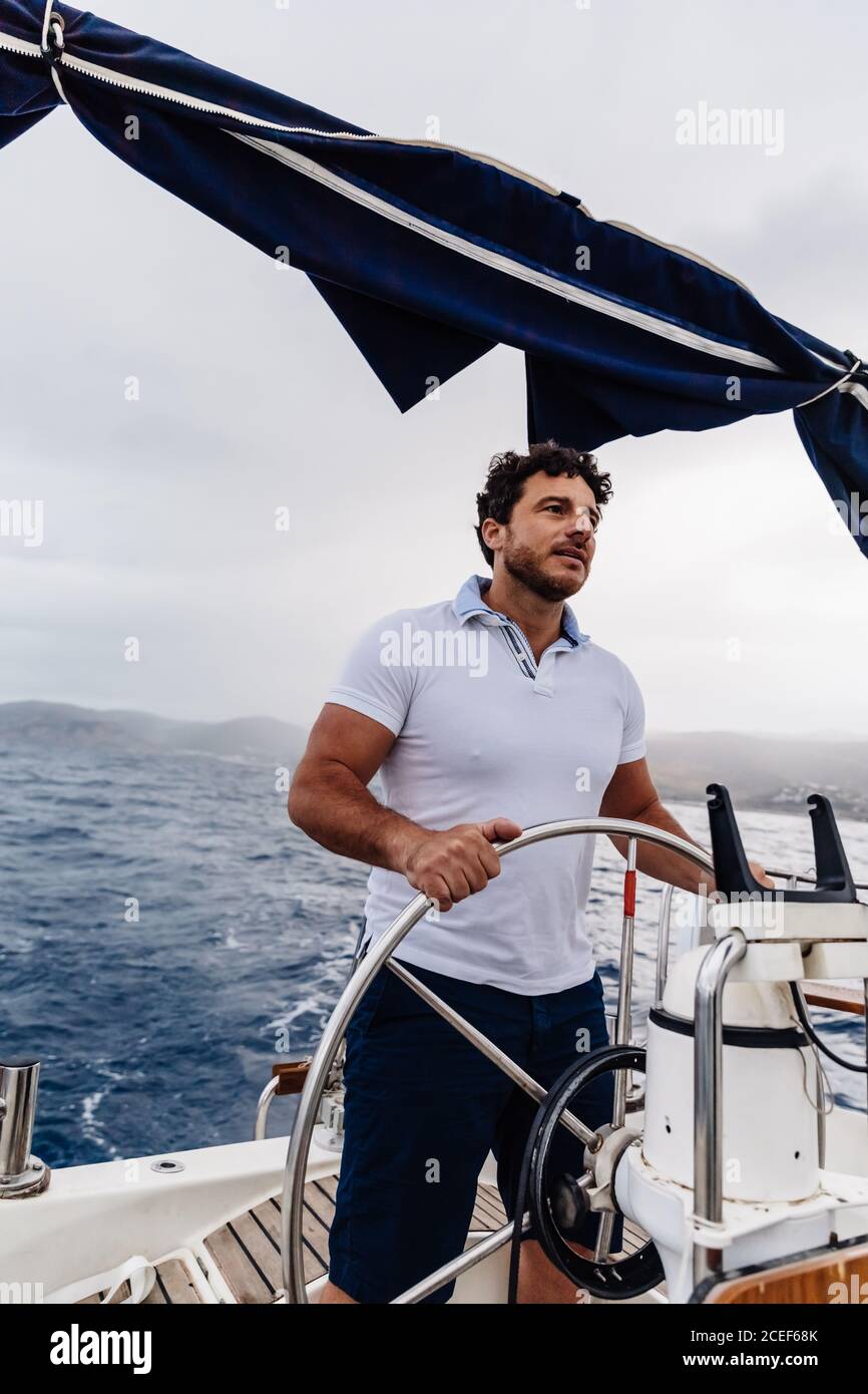 Captain of a ship sailing on a sailboat Stock Photo - Alamy
