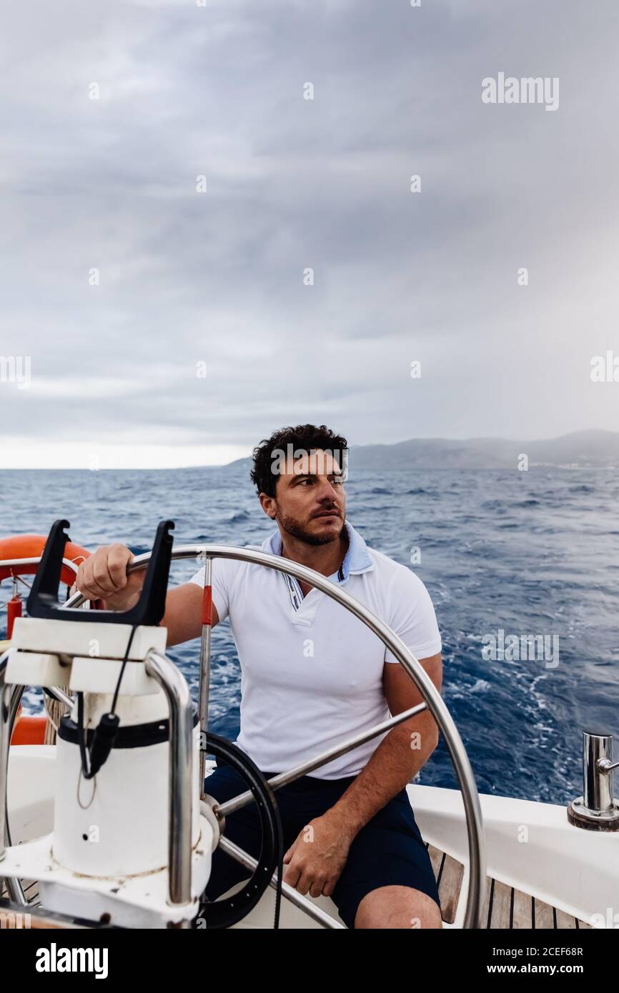 Captain of a ship sailing on a sailboat Stock Photo - Alamy
