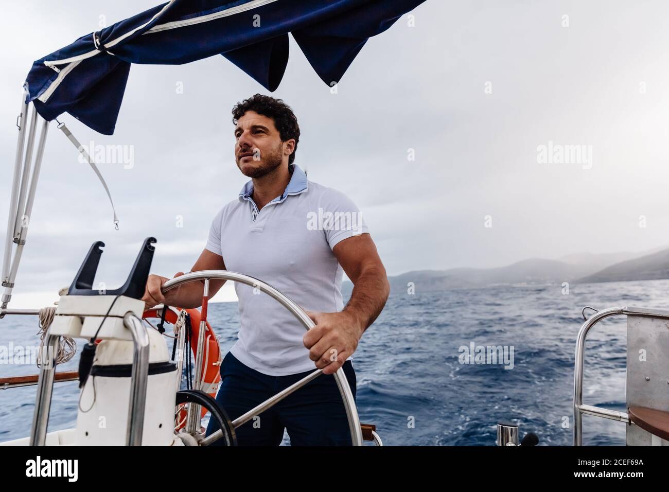 Captain of a ship sailing on a sailboat Stock Photo - Alamy