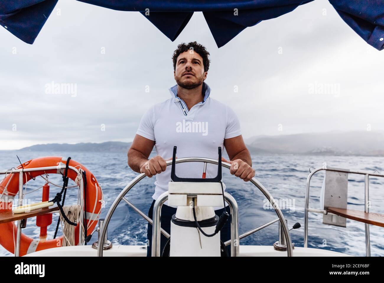 Captain of a ship sailing on a sailboat Stock Photo - Alamy
