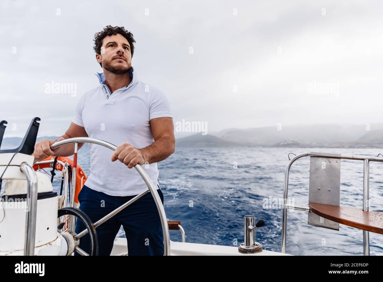 Captain of a ship sailing on a sailboat Stock Photo - Alamy