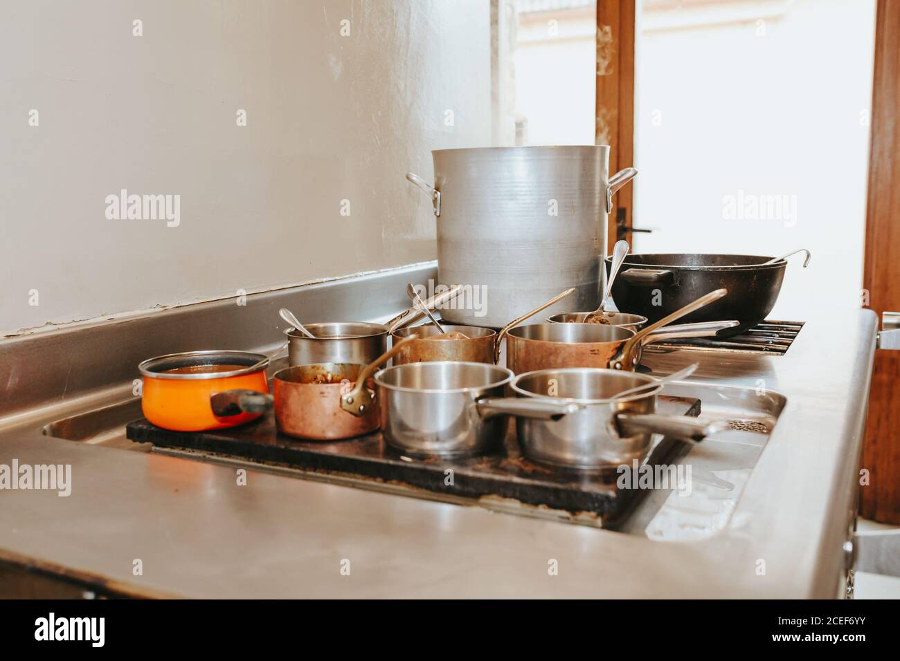 The different pots placed on a stove in the professional restaurant ...