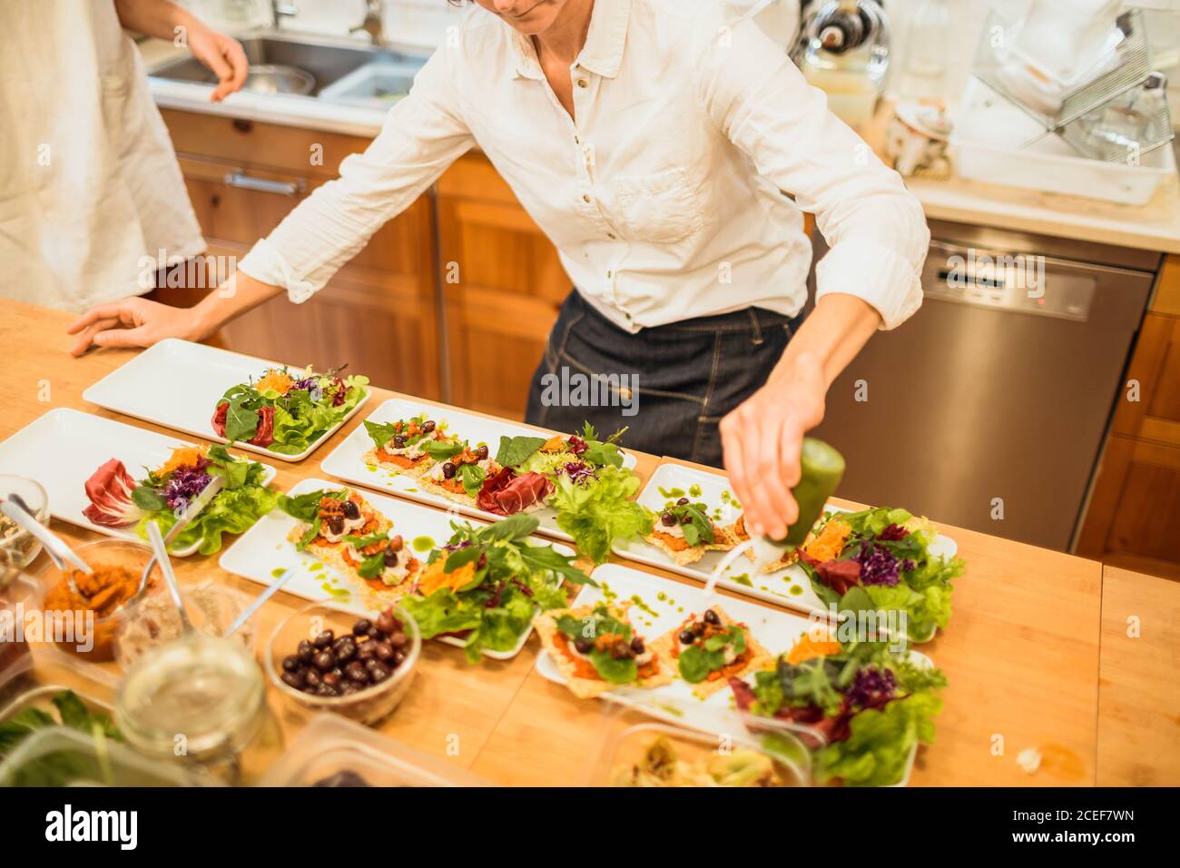 Two women cooking in cafe Stock Photo - Alamy
