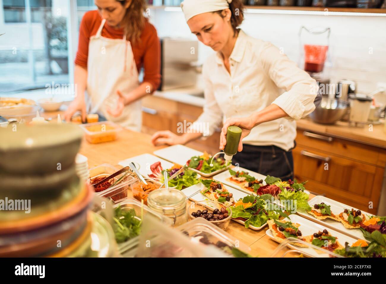 Two women cooking in cafe Stock Photo - Alamy