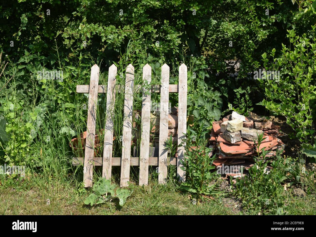 garden fence and bricks, rubble Stock Photo - Alamy