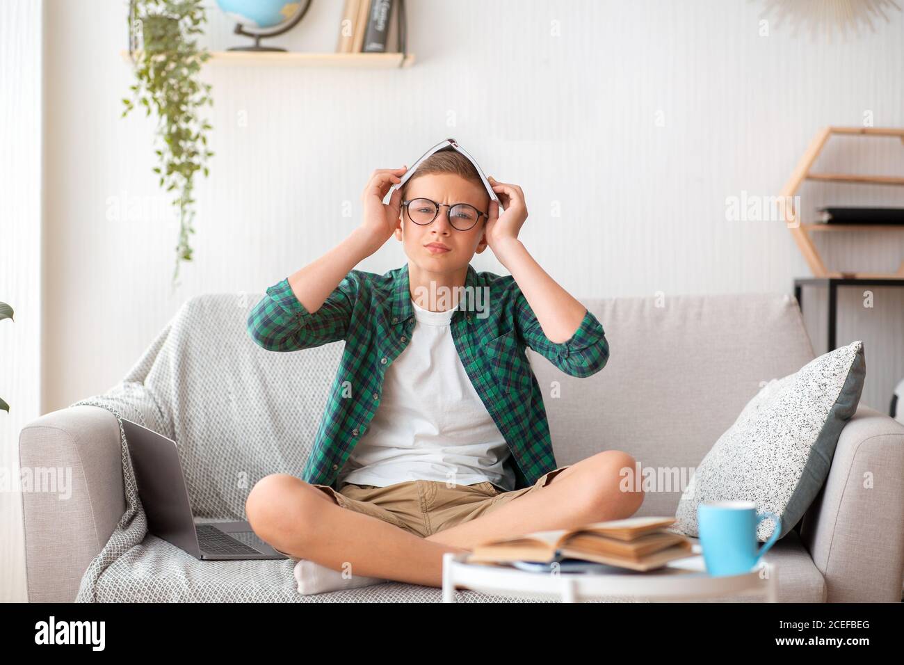 Tired school boy need break, studying at home alone Stock Photo - Alamy