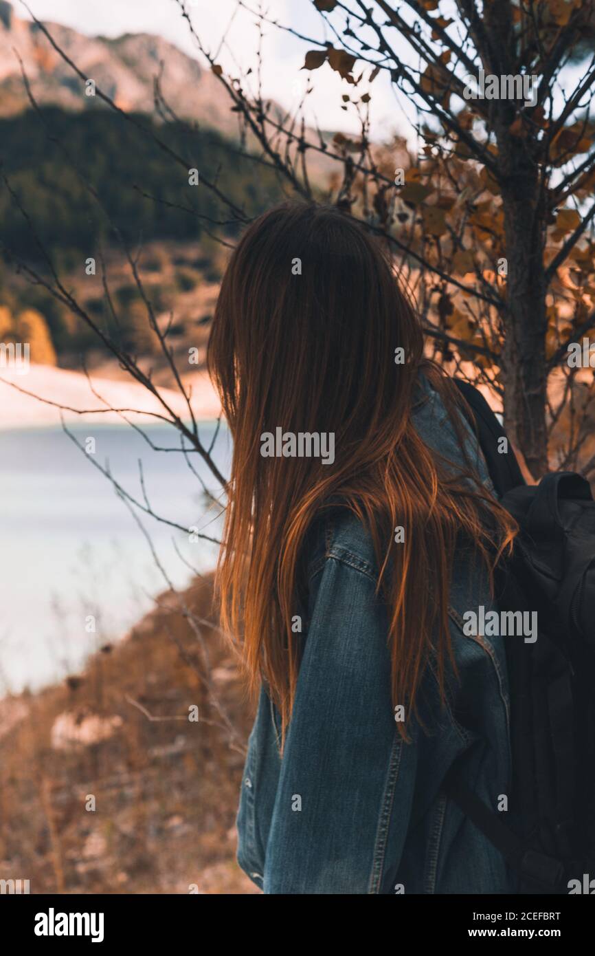 anonymous Woman standing on river coast Stock Photo - Alamy