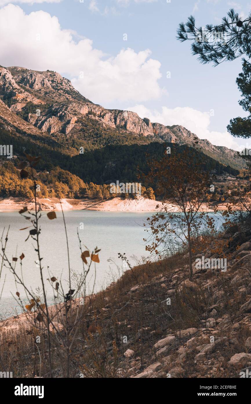 Lake near mountain slope Stock Photo - Alamy