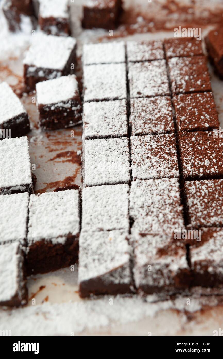 Delicious homemade raw chocolates cut into square shapes sprinkled with ...
