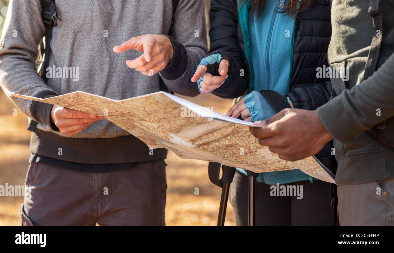 Cropped of travelers holding map, looking for their location Stock ...