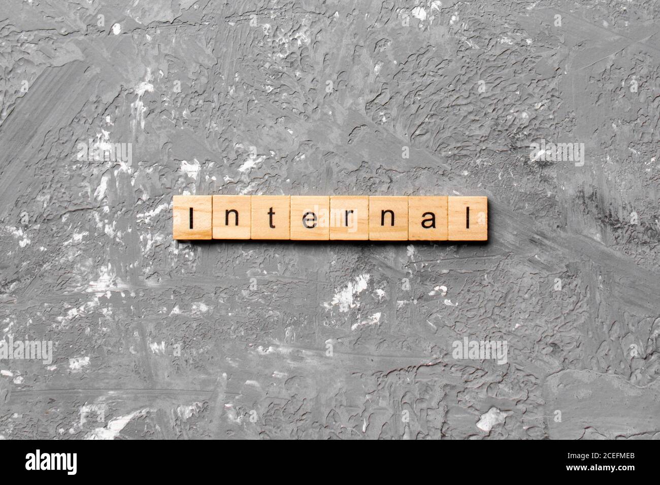 INTERNAL word written on wood block. INTERNAL text on cement table for ...