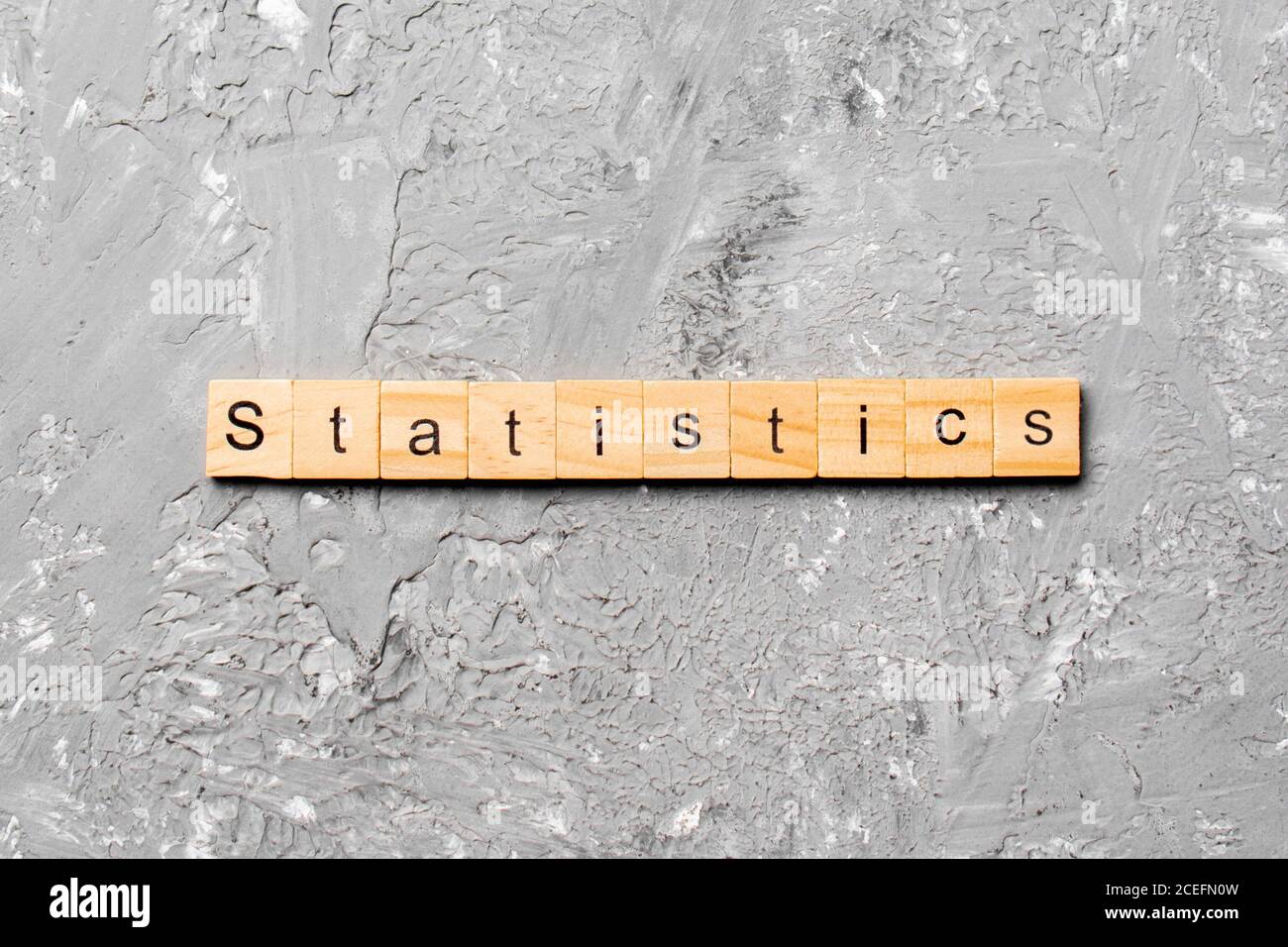statistics word written on wood block. statistics text on cement table ...
