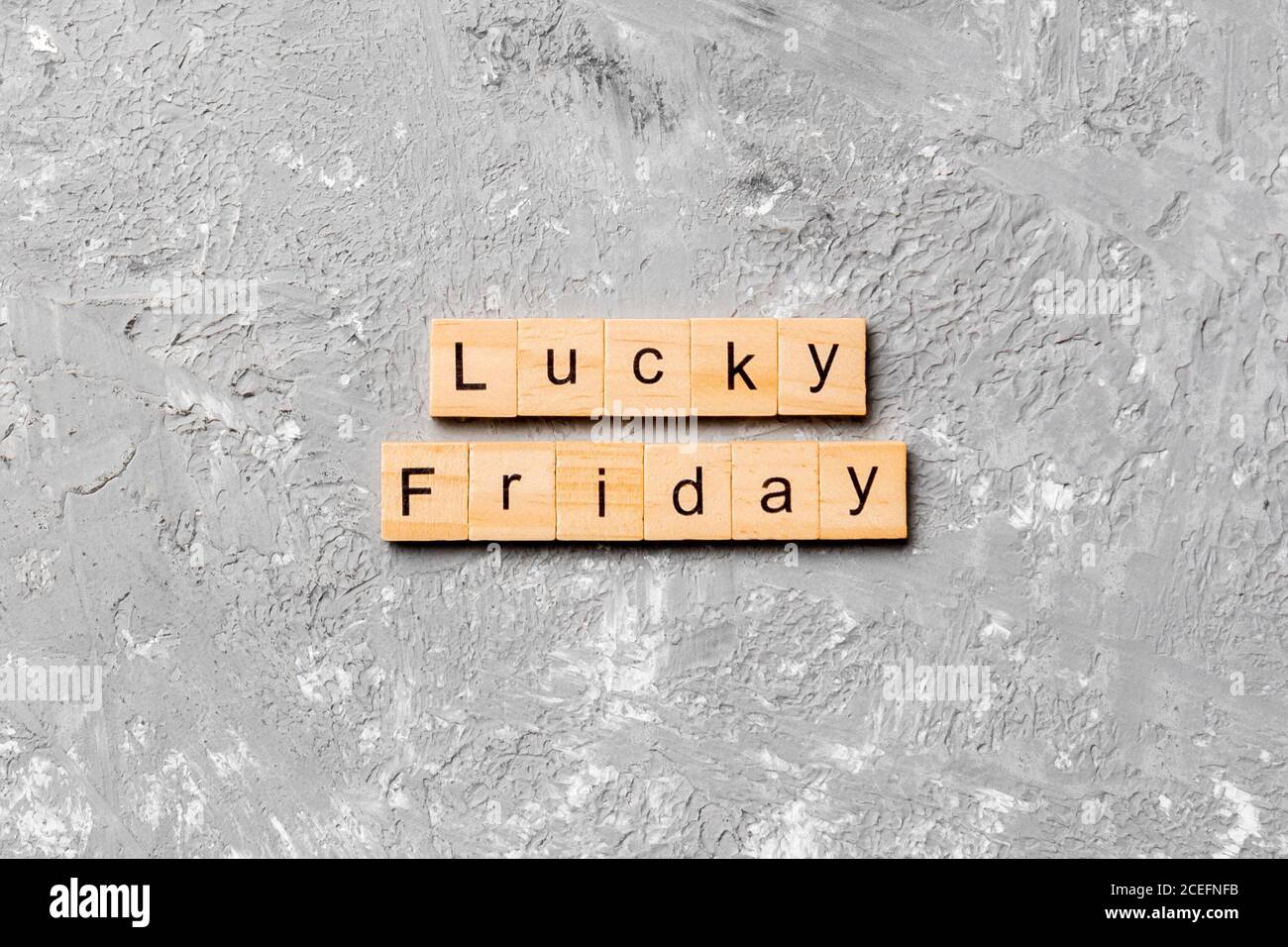lucky friday word written on wood block. lucky friday text on cement ...