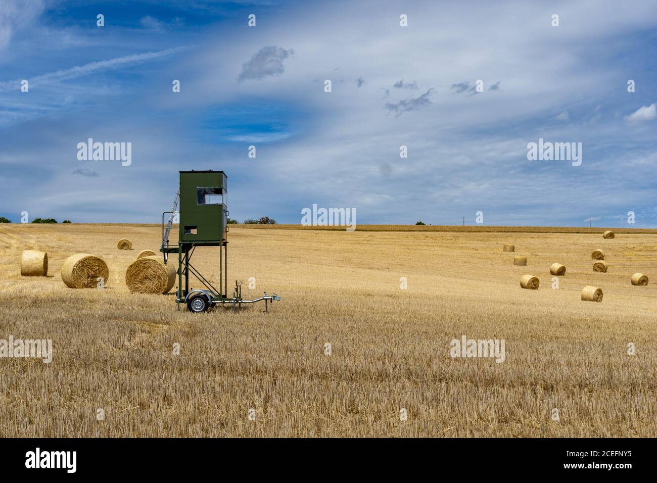 A high seat for hunting trailer parked i na golden wheat field Stock ...