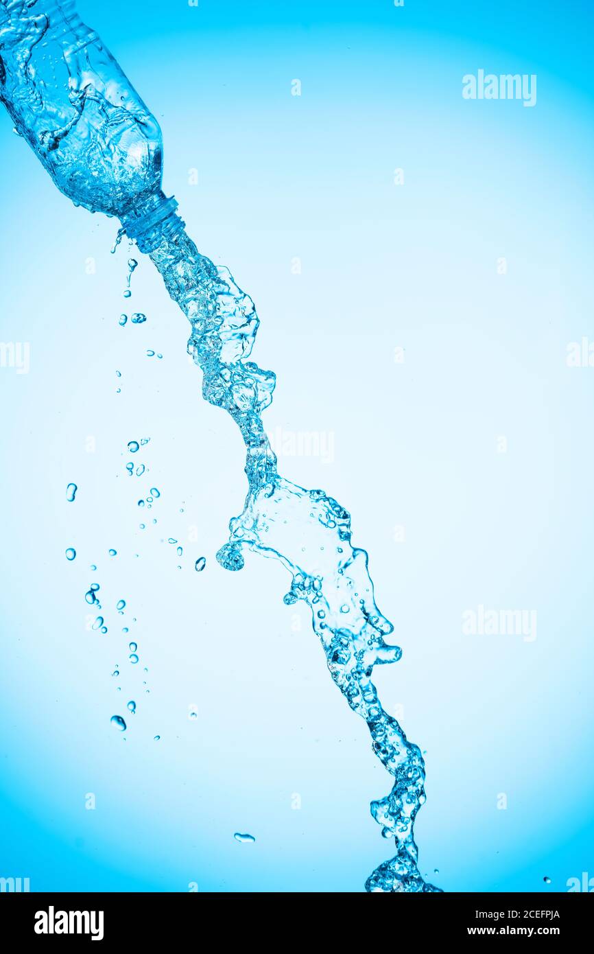 Water is poured out of a plastic bottle. Copy space Stock Photo - Alamy