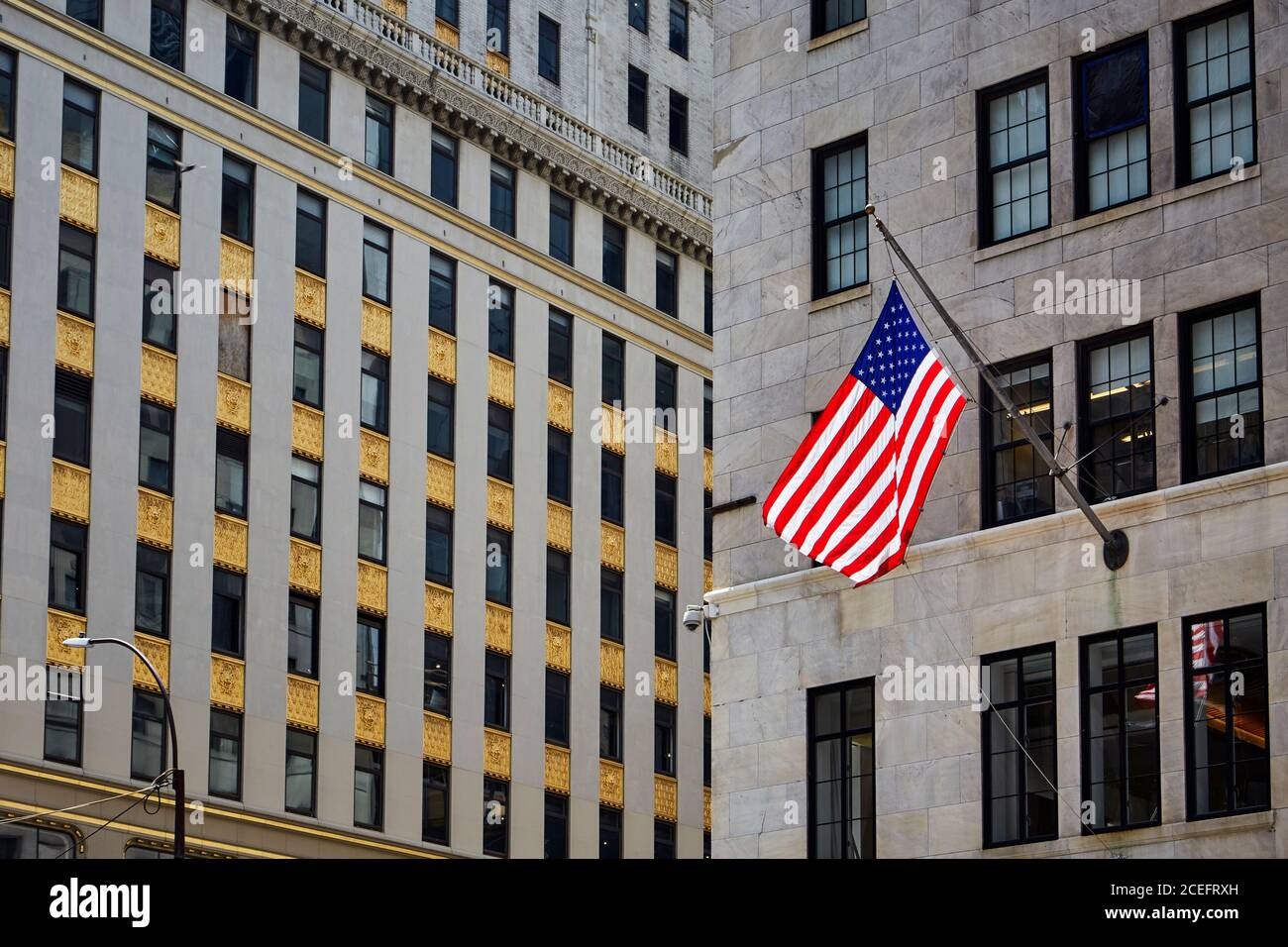 Flag of USA hanging on facade of modern building on street of New York ...