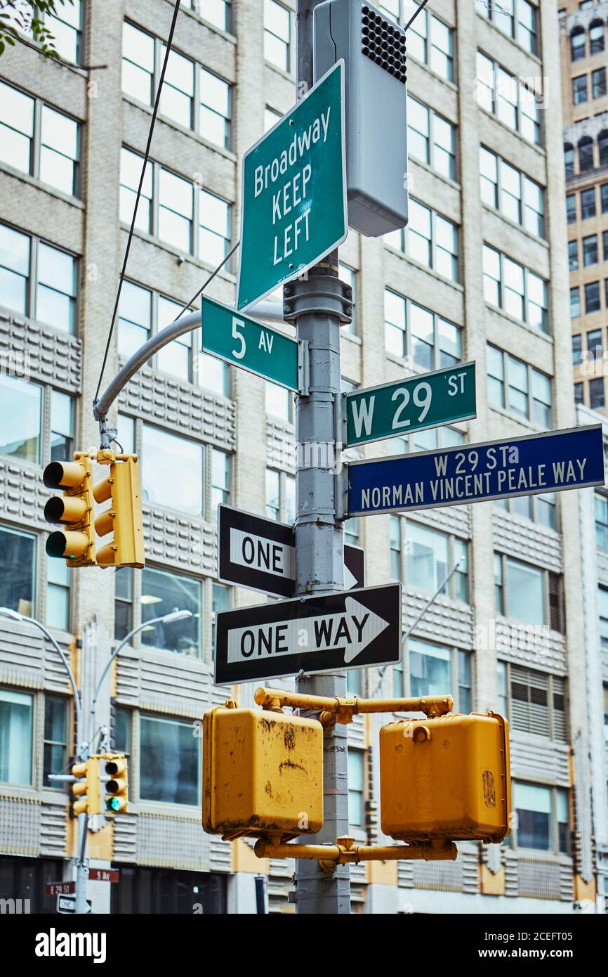 Signpost with traffic lights standing on intersection in downtown of ...