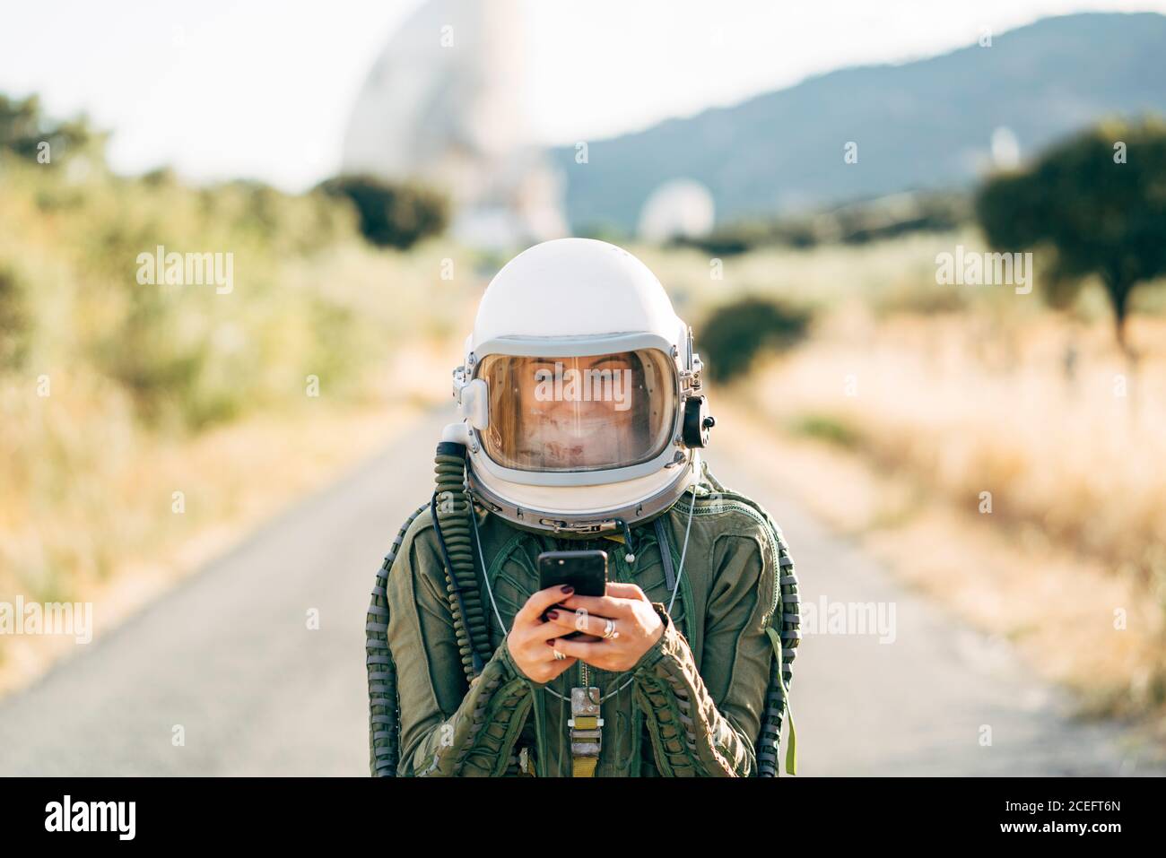 Beautiful female astronaut with mobile phone Stock Photo - Alamy