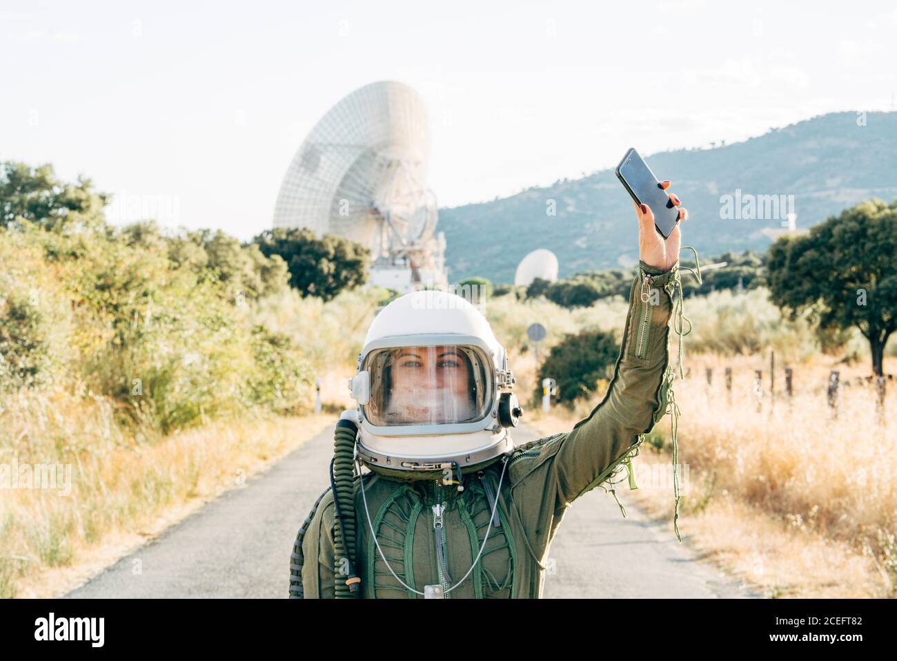 Beautiful female astronaut with mobile phone Stock Photo - Alamy