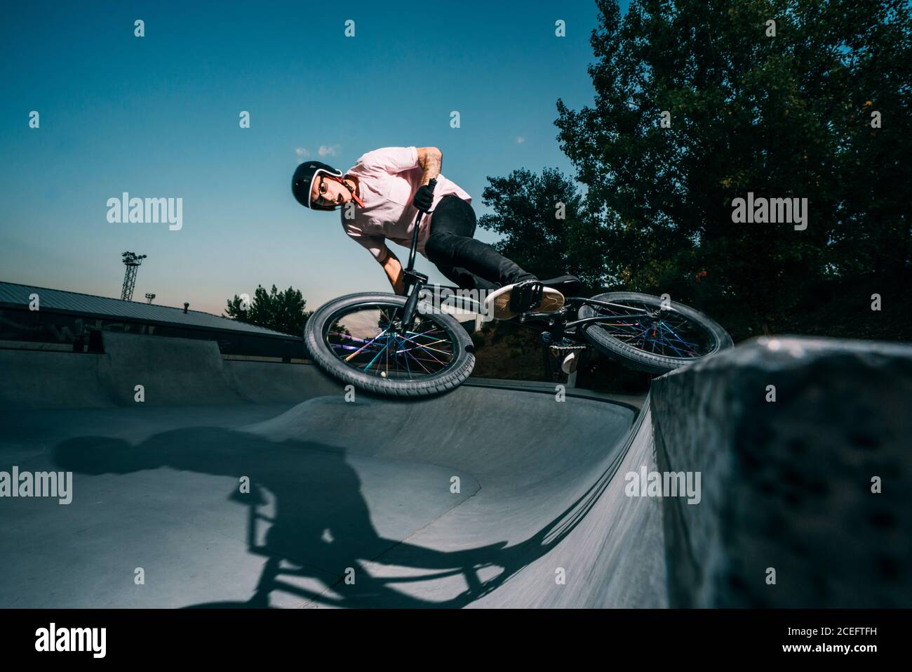 man riding bicycle on springboard Stock Photo - Alamy