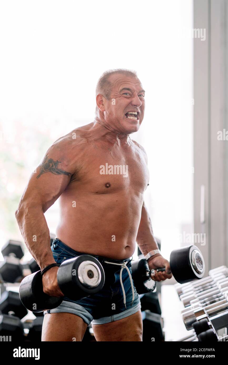Muscular older man posing Stock Photo - Alamy