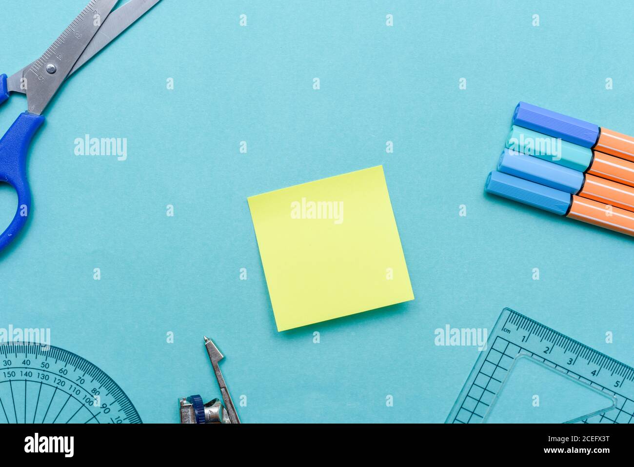 Blank sticky note for message with school stationary Stock Photo - Alamy