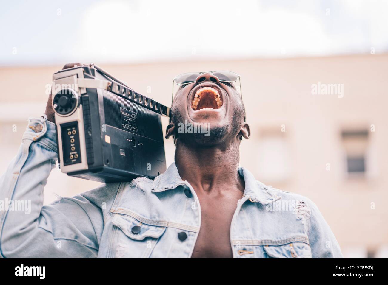African man with vintage radio device Stock Photo - Alamy