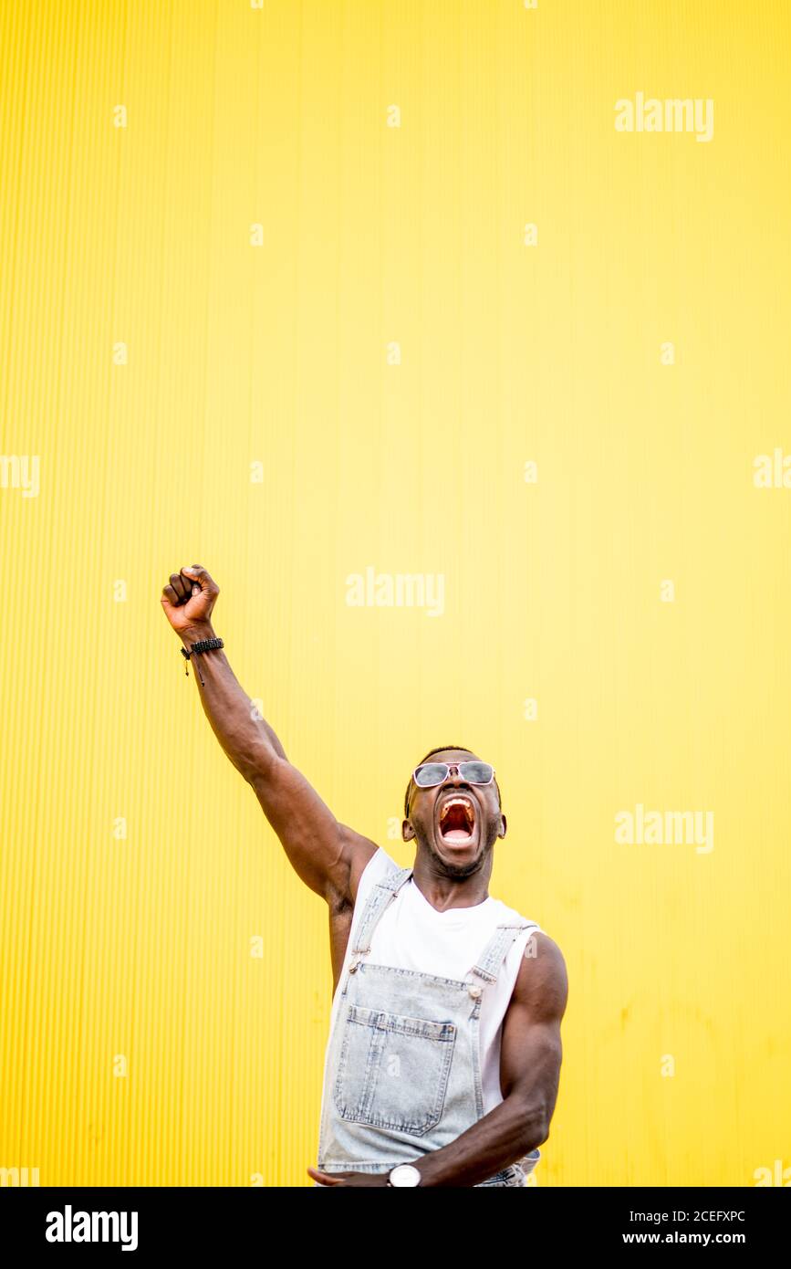 African man shouting victory clenched fist Stock Photo - Alamy