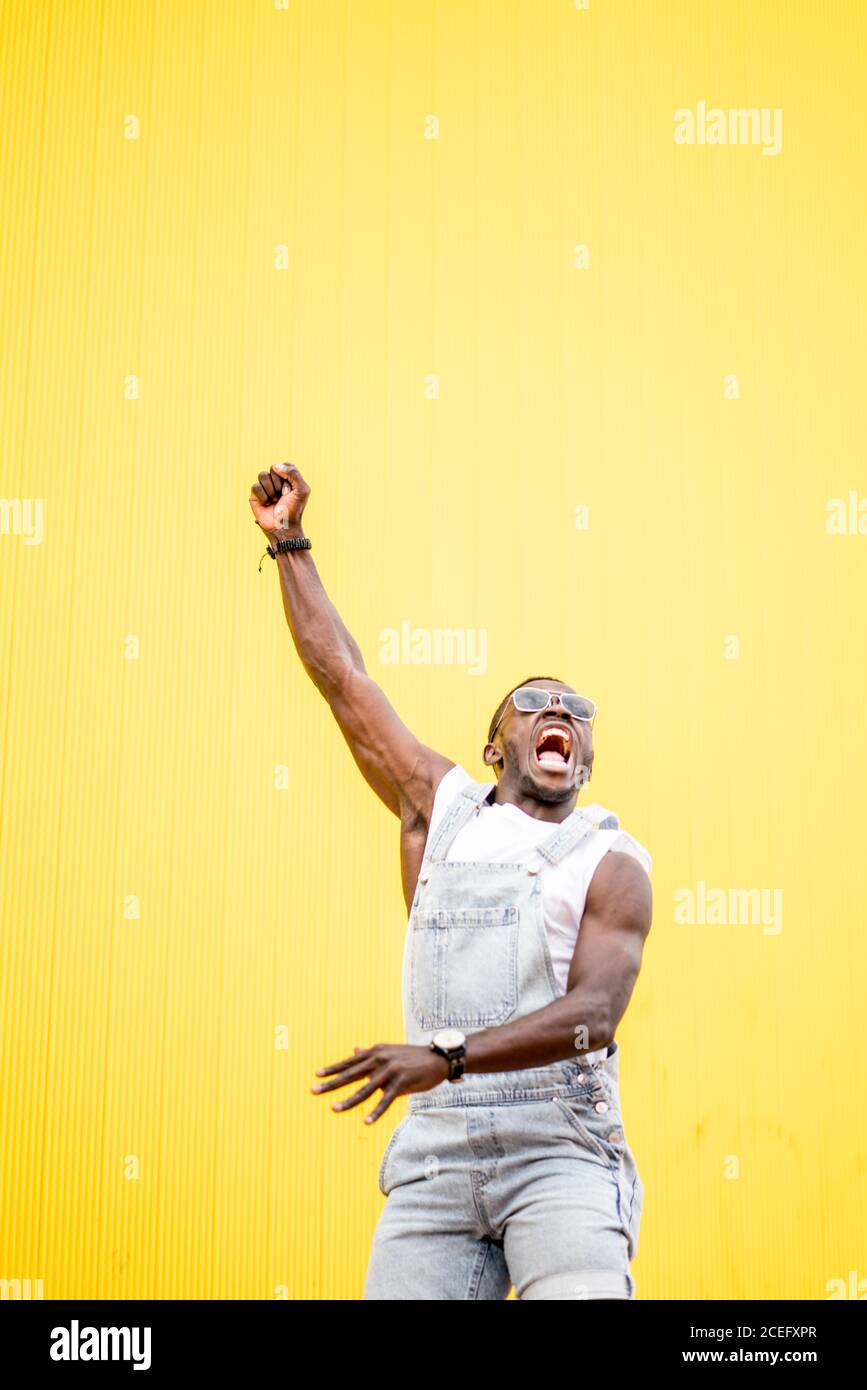 African man shouting victory clenched fist Stock Photo - Alamy