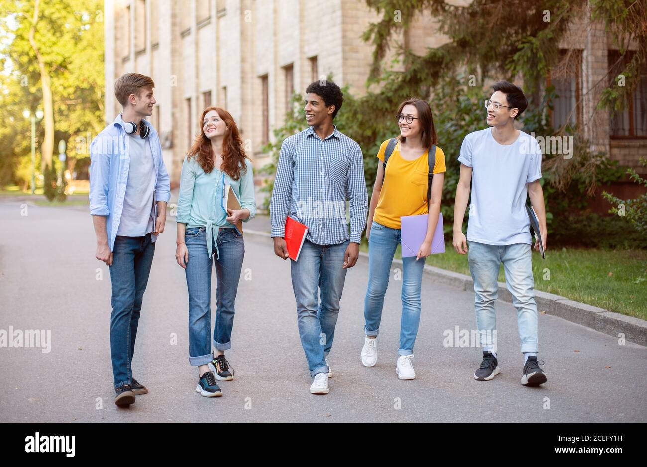 Multiracial High-School Students Walking In University Campus Outdoors ...