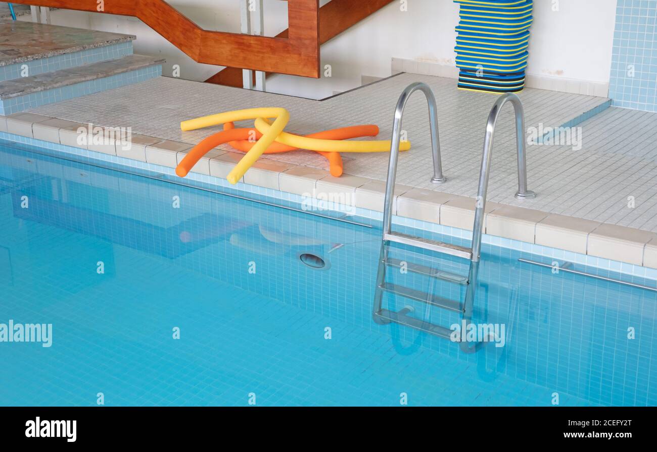 Metal stairs in an indoor swimming pool Stock Photo - Alamy