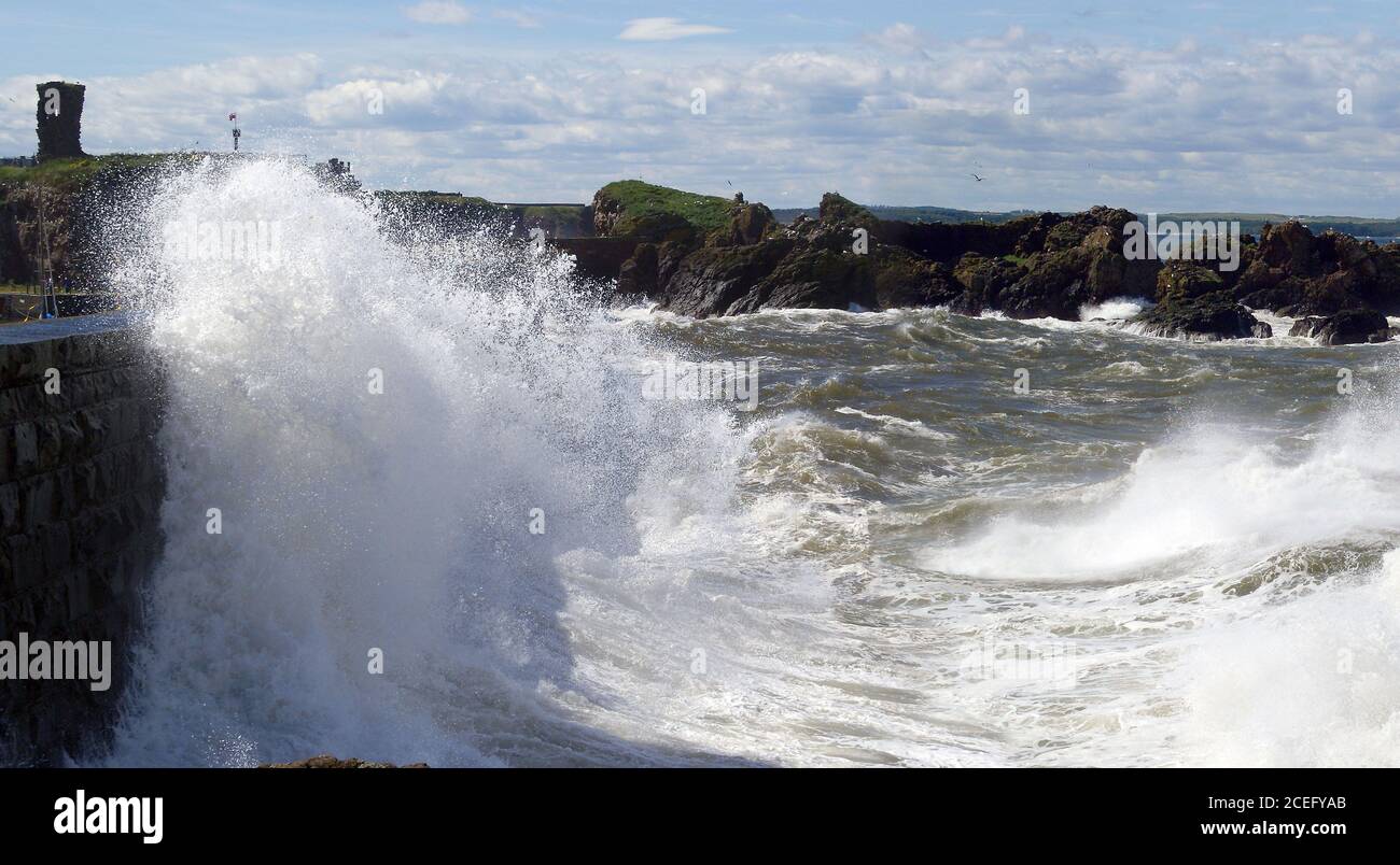 Waves battering the sea walls of Dunbar Harbour Stock Photo - Alamy