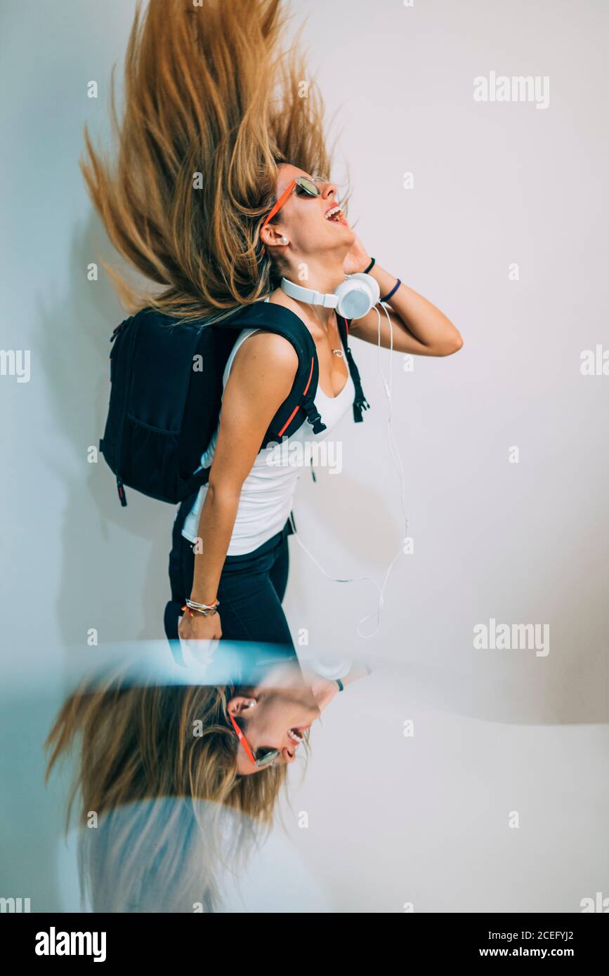 Woman with headset dancing in studio Stock Photo - Alamy