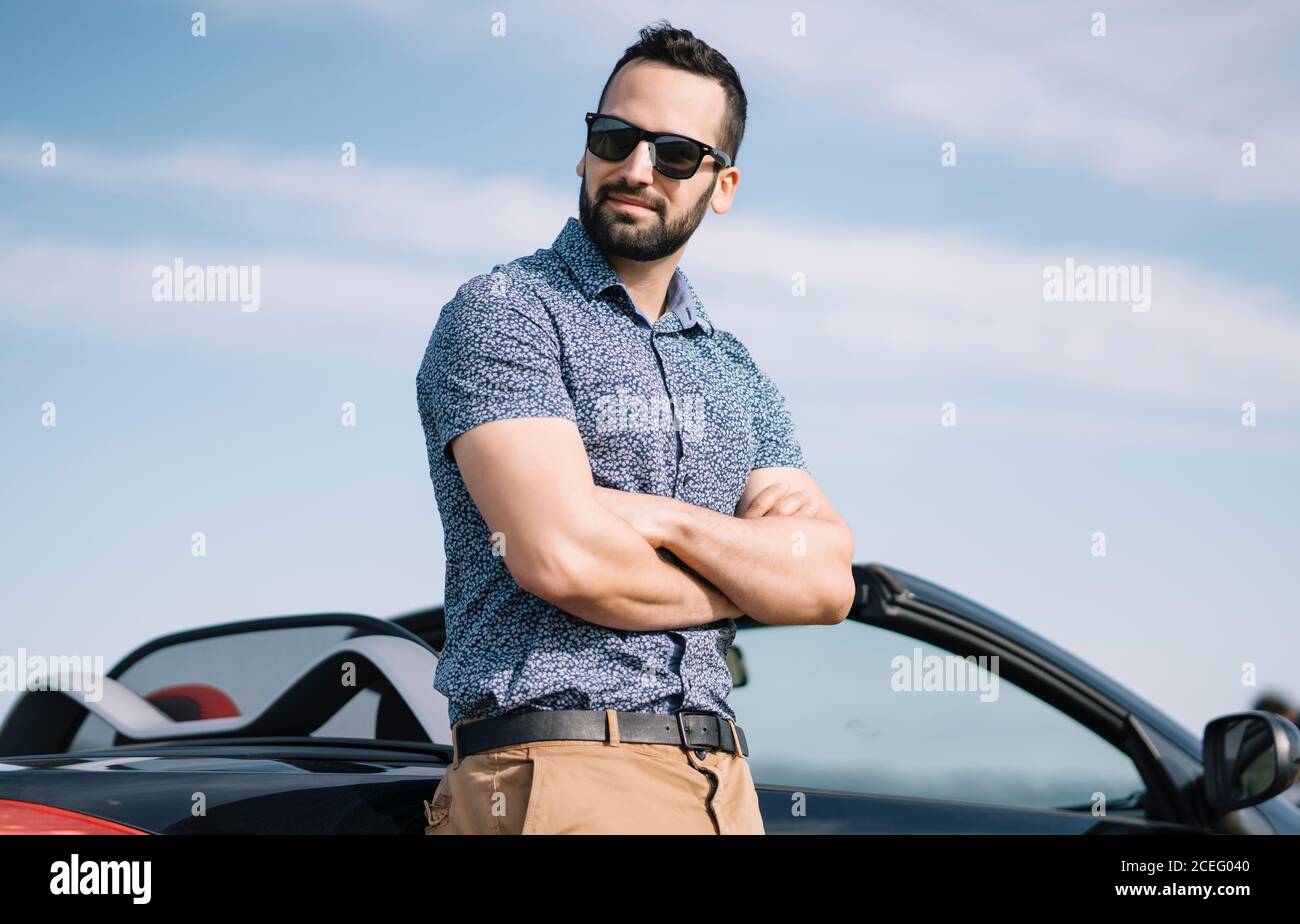 Attractive man posing in convertible car Stock Photo - Alamy