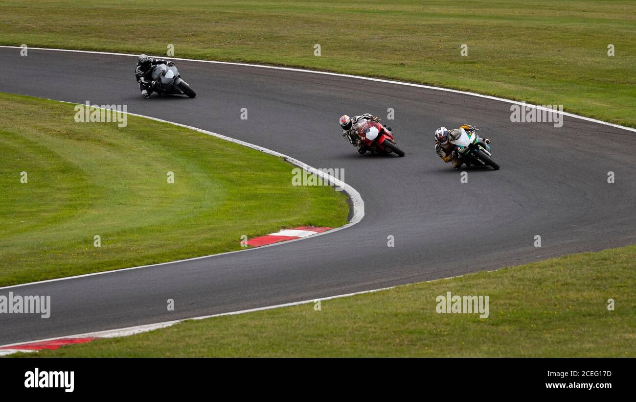 A shot of several racing bikes cornering as they circuit a track Stock ...