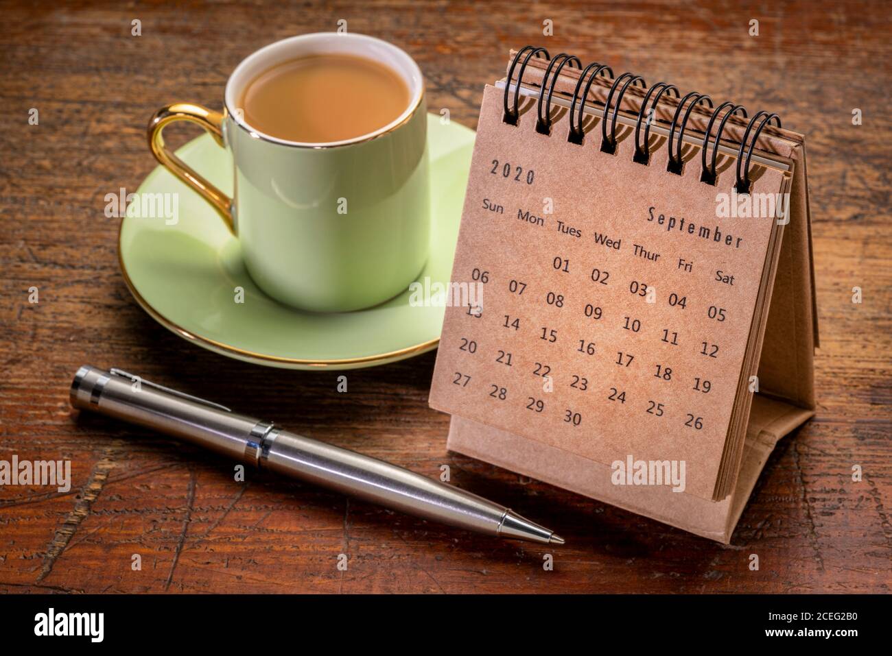 September 2020 - spiral desktop calendar on a rustic wood table with a ...