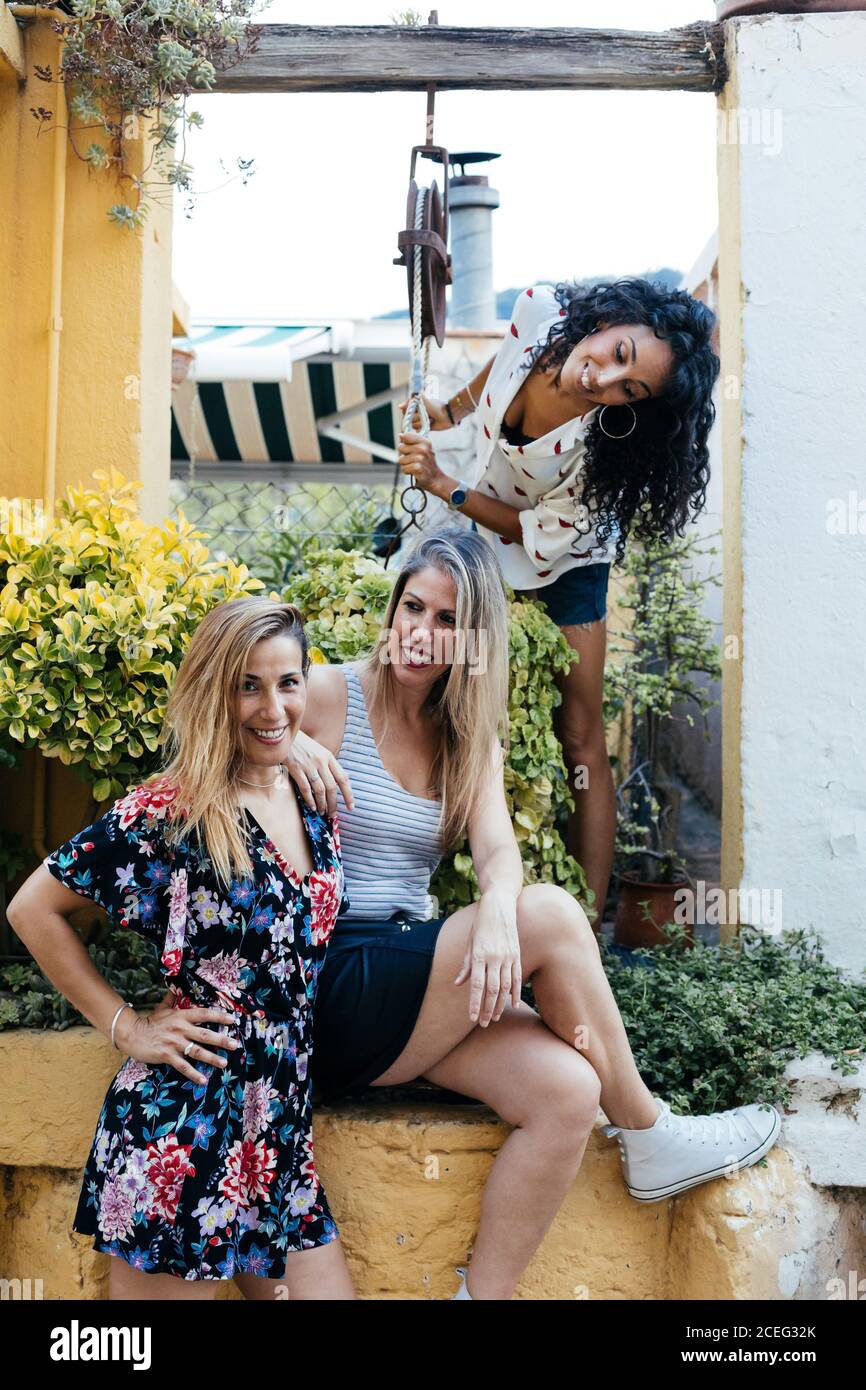 Three girls posing on the street Stock Photo - Alamy