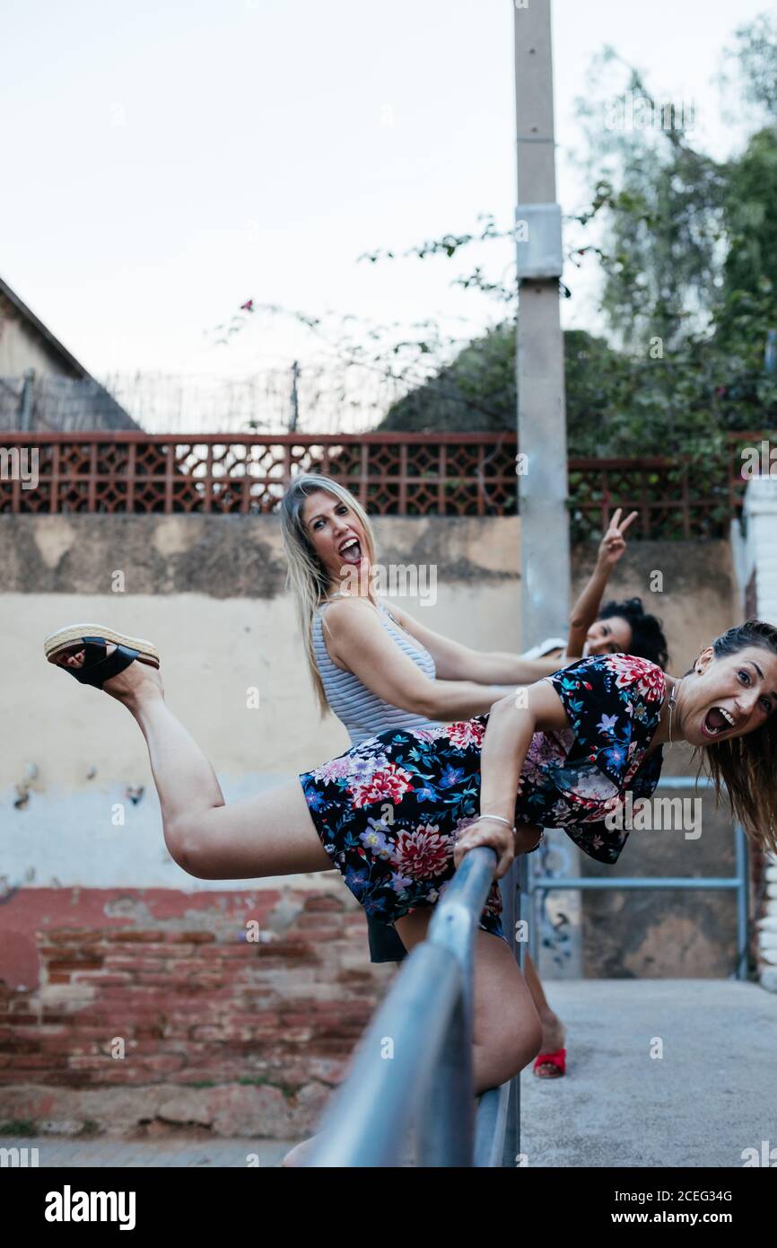 Three girls playing on the street Stock Photo - Alamy