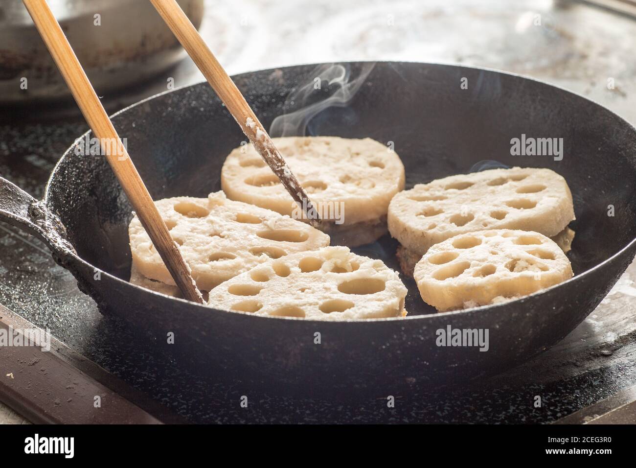 Cooking lotus root meat stuffed sandwiches Stock Photo - Alamy
