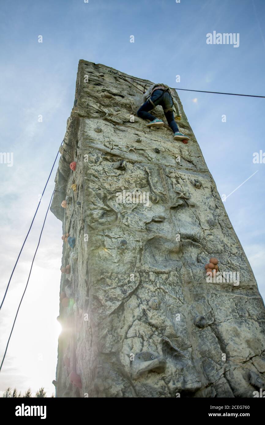 Vertical low angle shot of a person climbing a wall Stock Photo - Alamy