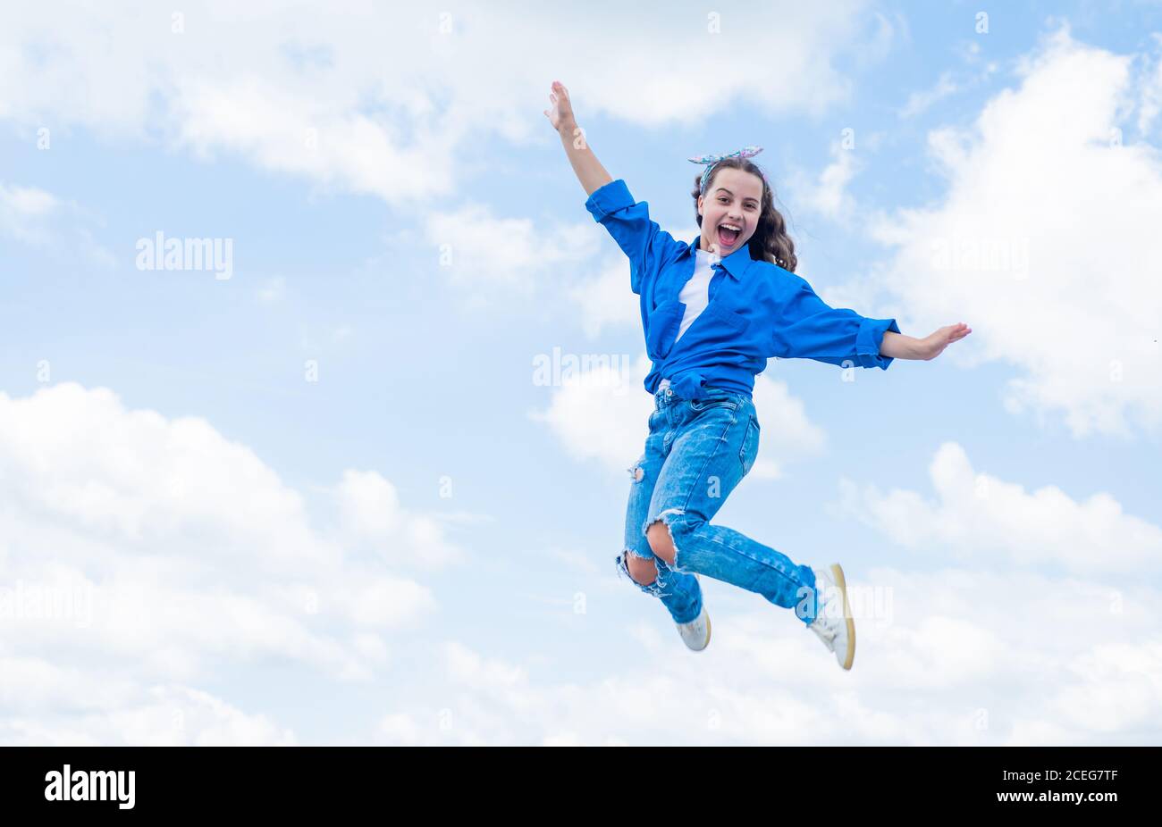 cheerful teen girl jumping high. kid jump outdoor. kid fashion and ...