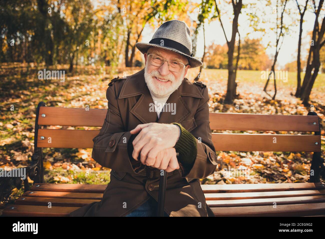 Hello autumn. Photo of positive old man rest relax in fall nature town ...