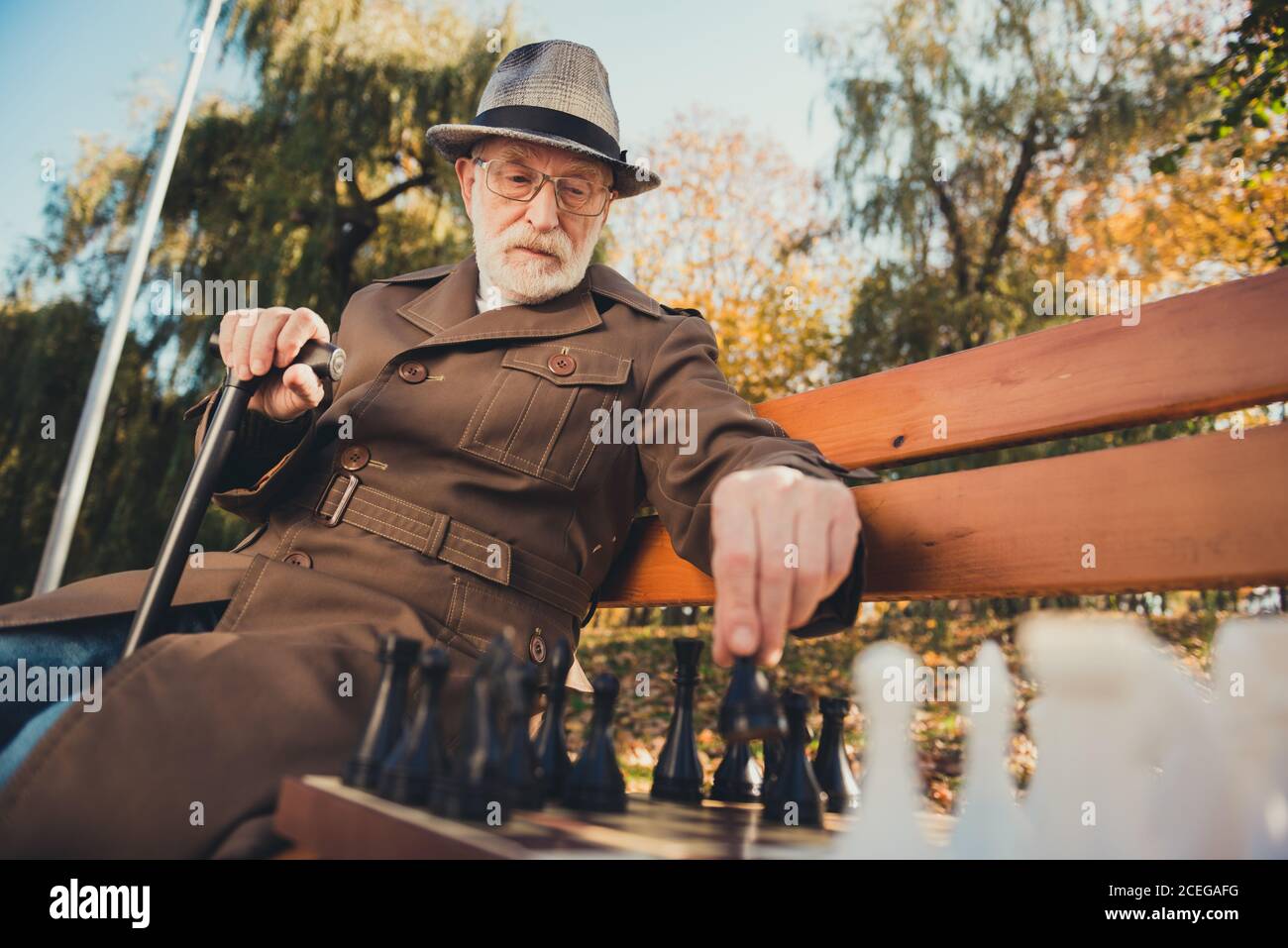 Low angle view photo of focused skilled old man rest relax sunset ...