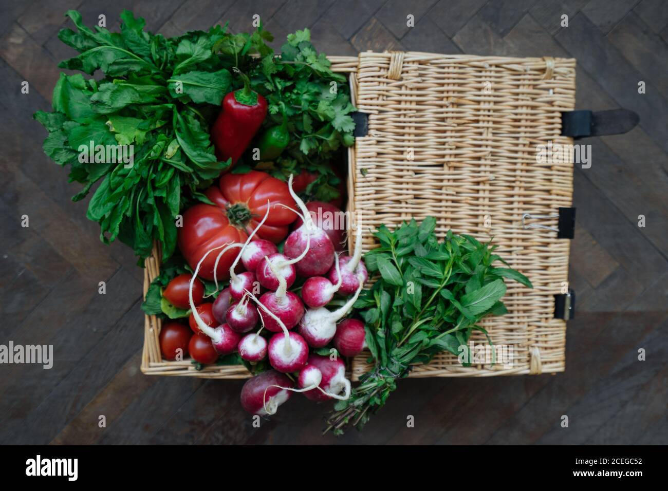 Crop Woman in shirt and skirt holding in hands basket with open lid ...