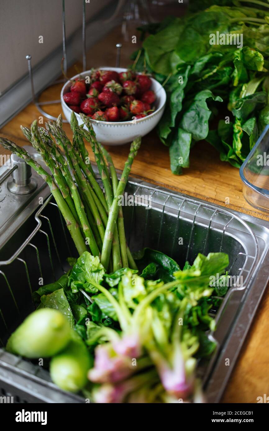 Woman washing fresh vegetables in kitchen Stock Photo - Alamy