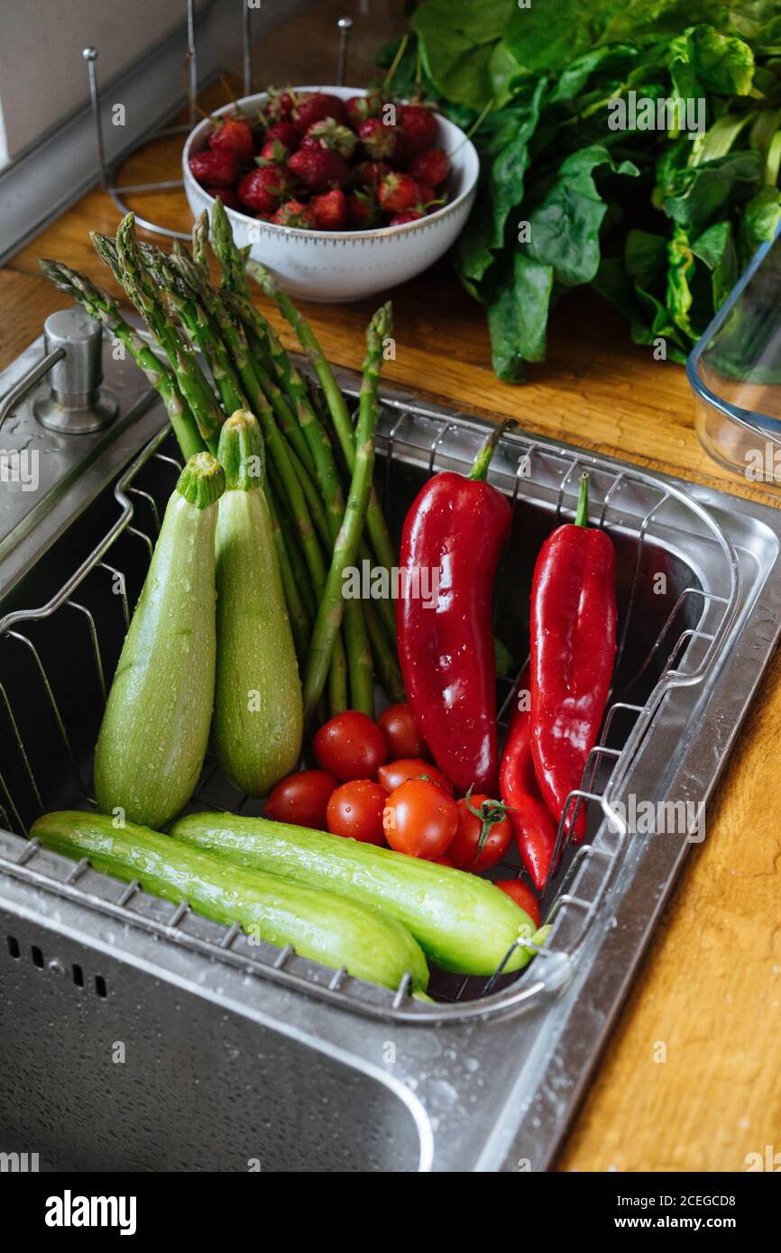 Woman washing fresh vegetables in kitchen Stock Photo - Alamy
