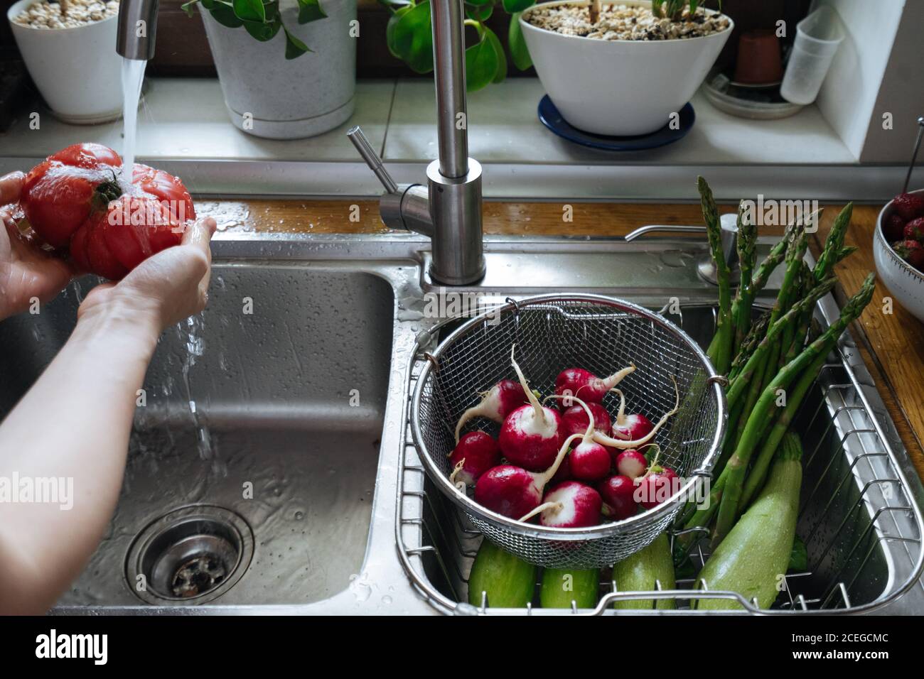 Woman washing fresh vegetables in kitchen Stock Photo - Alamy