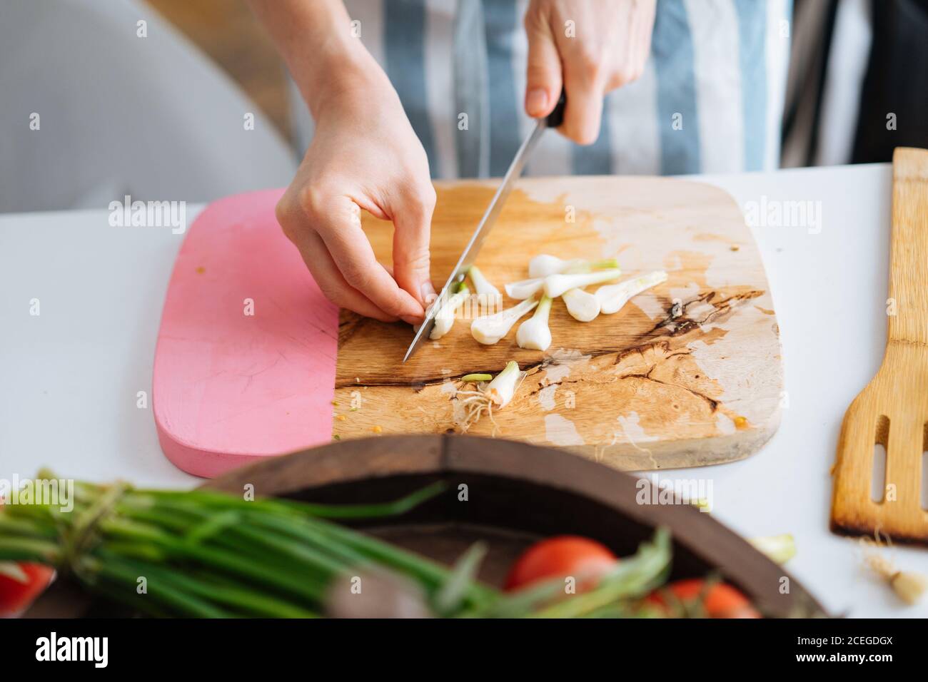 Female cutting vegetables with knife Stock Photo - Alamy
